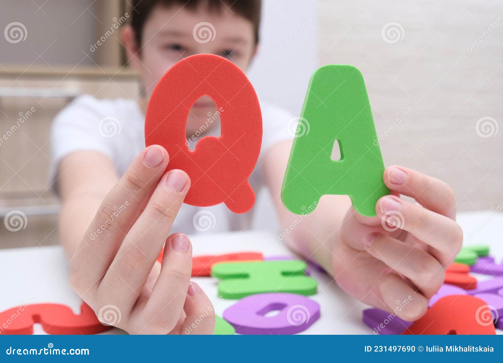 A Boy Holding Colorful Letters Q and a, Questions and Answers Concept ... A Boy Holding Colorful Letters Q and a, Questions and Answers Concept ...
