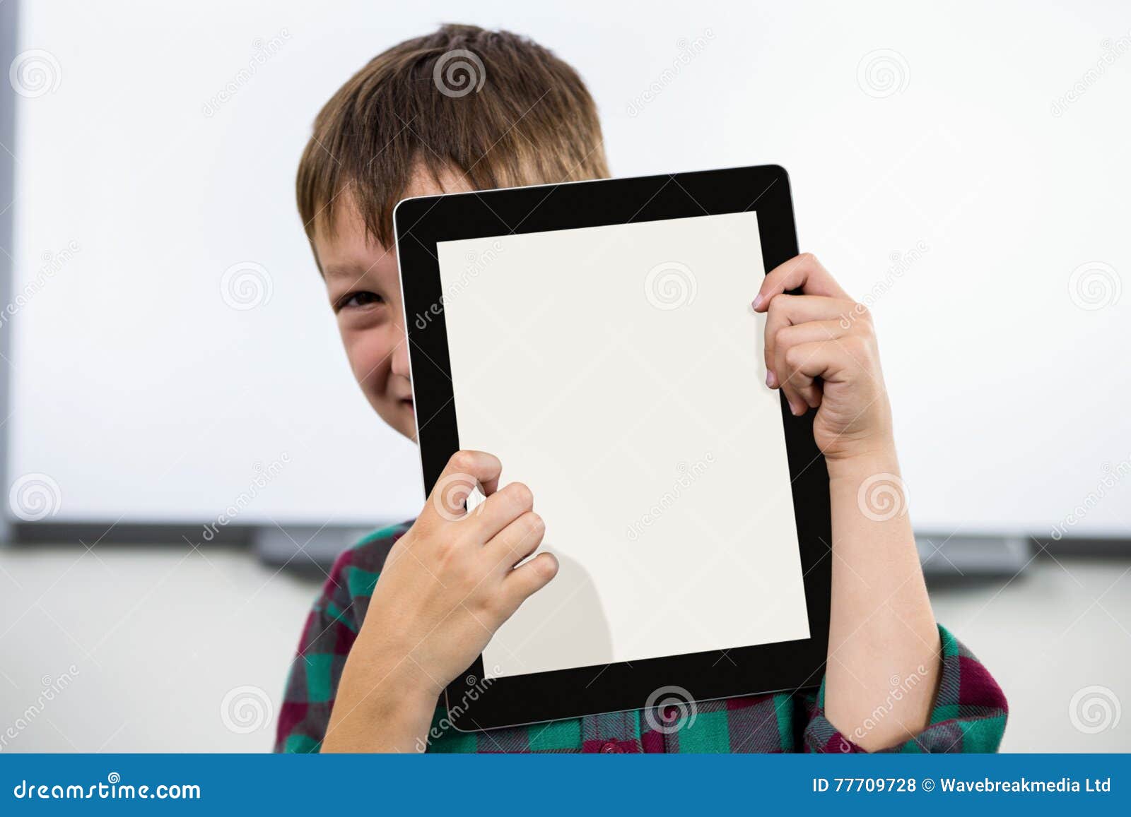Boy Holding Digital Tablet in Classroom Stock Photo - Image of indoors ...