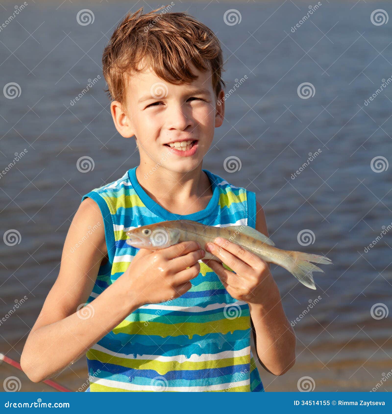 Boy Holding Fish and Smiling Stock Image - Image of animal, large: 34514155