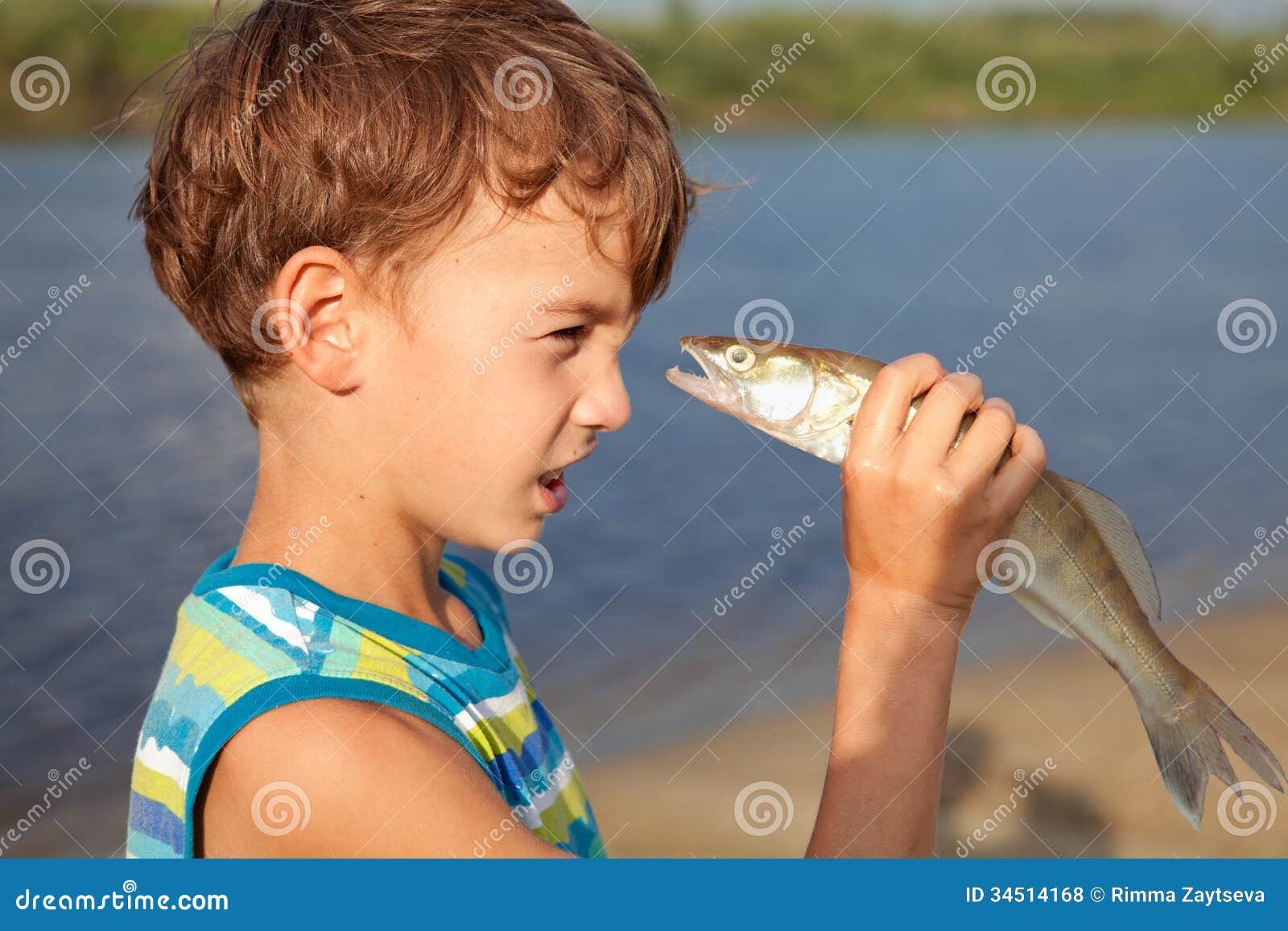 Boy Holding Fish and Smiling Stock Photo - Image of large, holding ...
