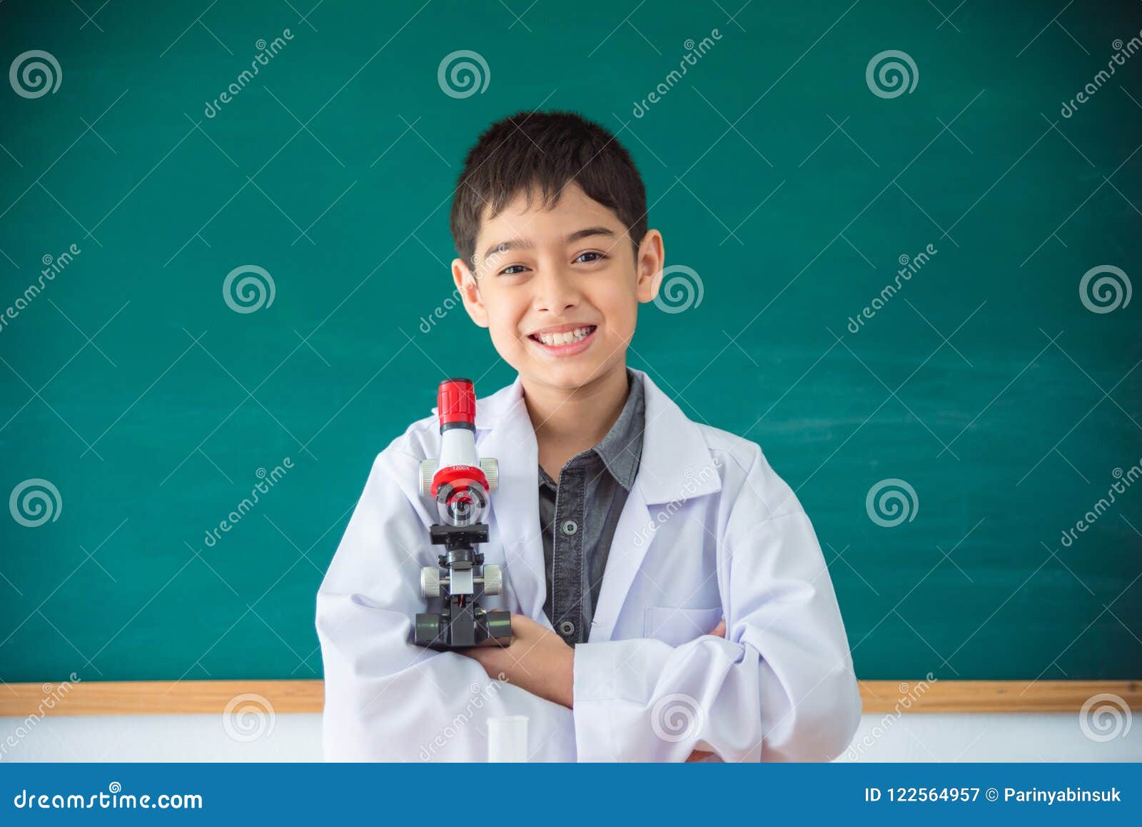 Boy Holding Microscope Smiling in Front of Classroom Stock Image ...