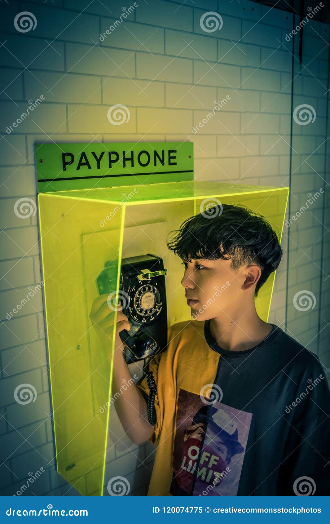 Boy Holding Payphone Receiver Picture. Image: 120074775