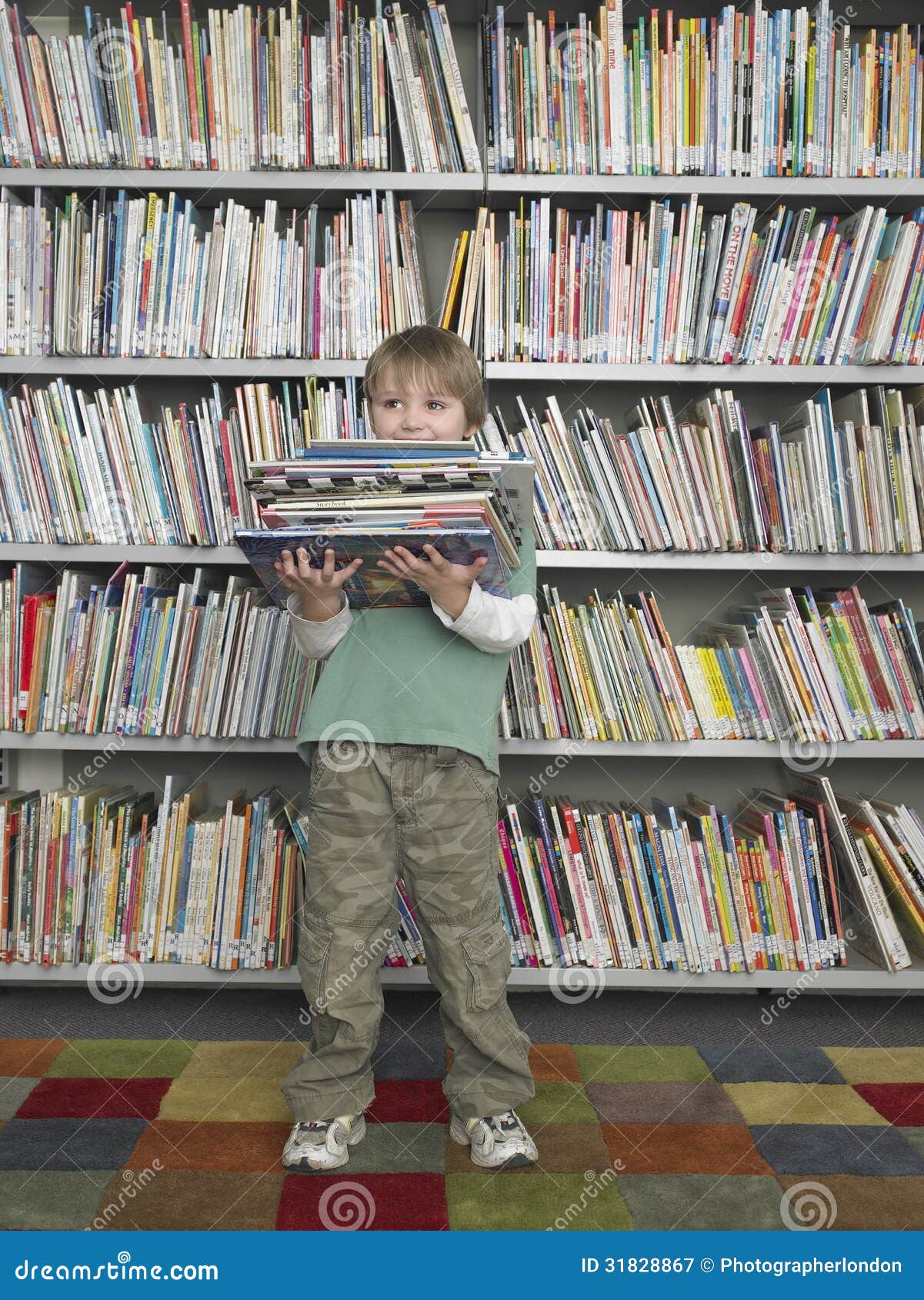 Boy Holding Stack of Books in Library Stock Image - Image of elementary ...
