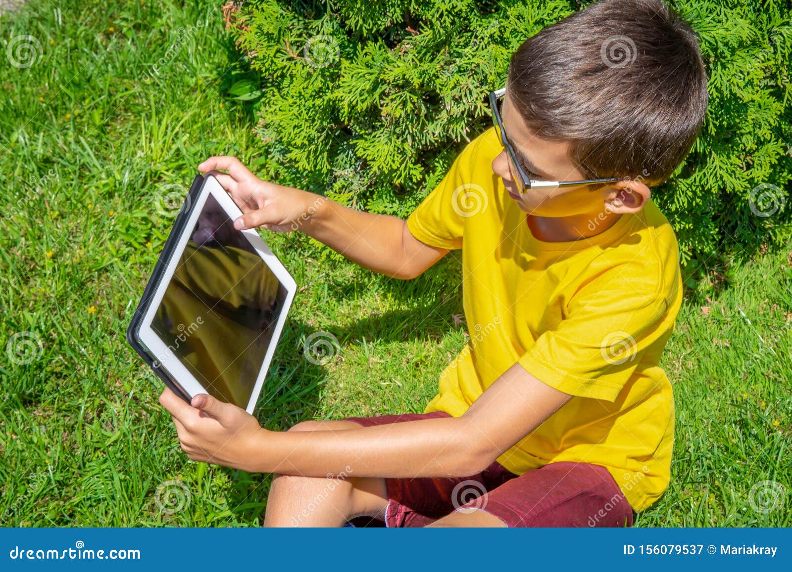 Boy Holding Tablet PC on Green Grass Lawn Stock Image - Image of ...