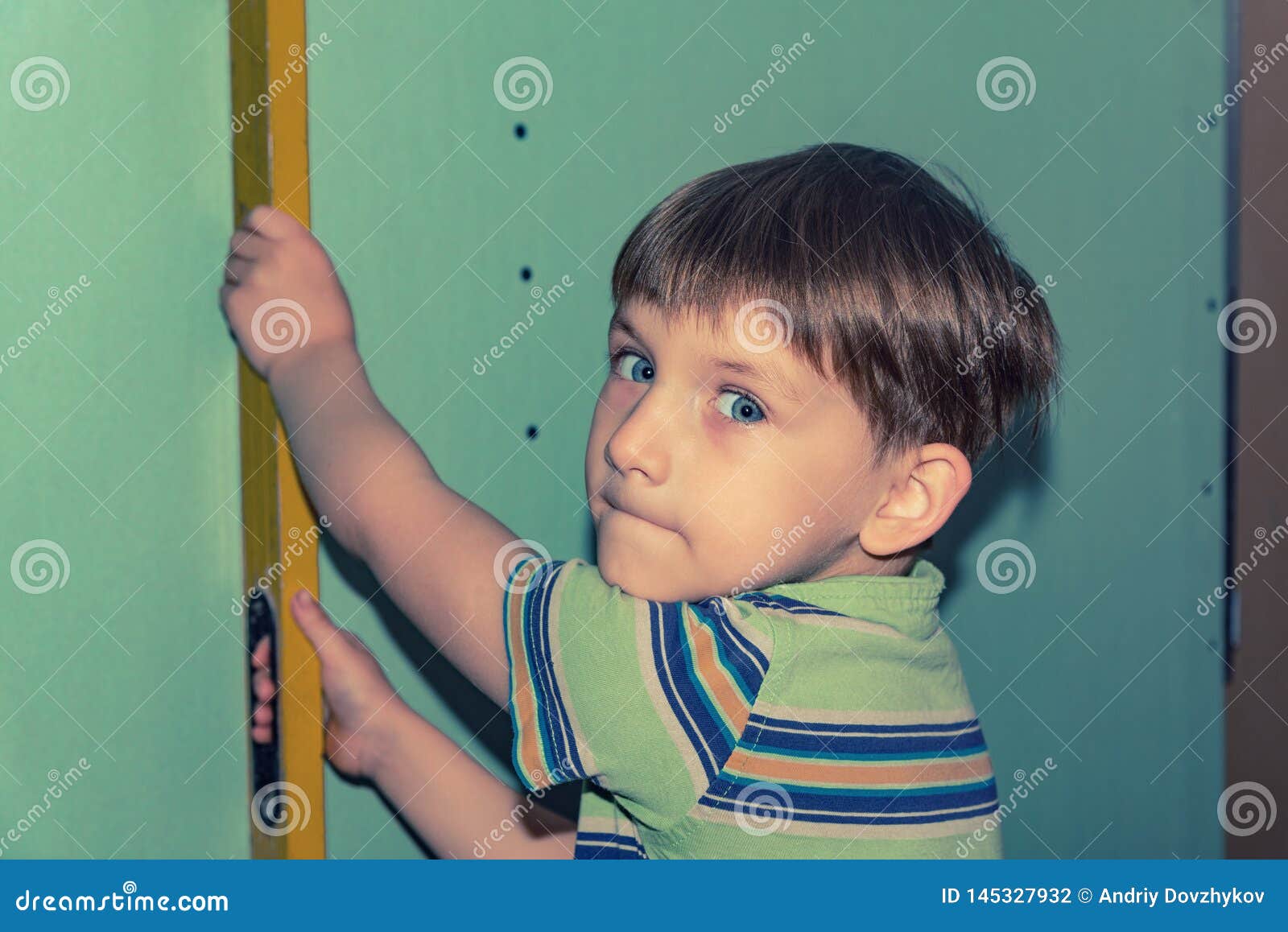 The Boy Holds the Building Level, Checking the Accuracy of the Wall ...