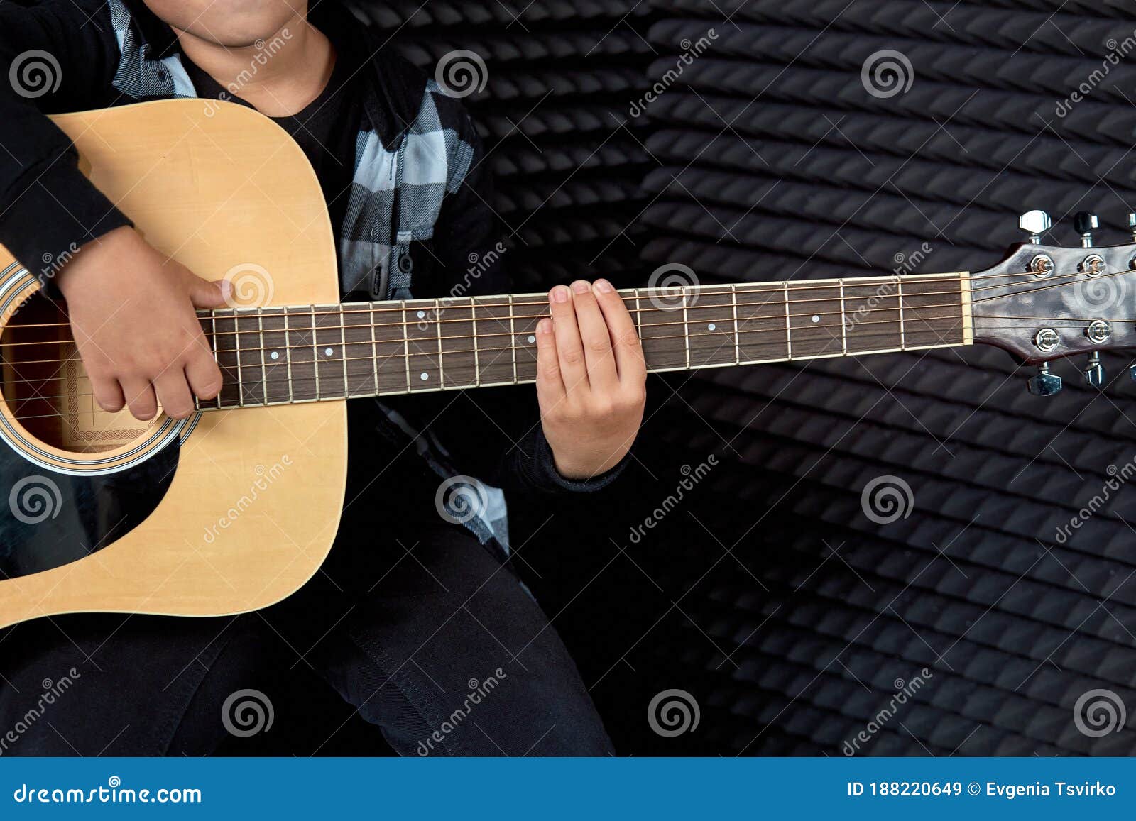 The Boy Holds a Guitar in His Hand and Fingers on the Strings. without ...