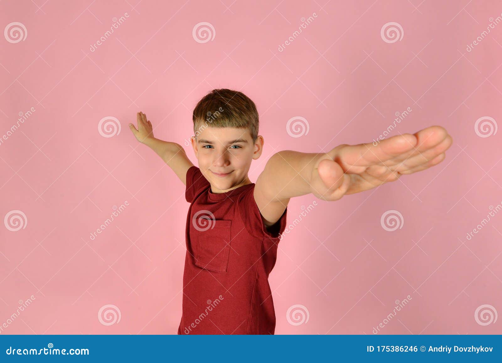 The Boy Holds His Hands To the Sides, One Arm Extended Forward, the ...