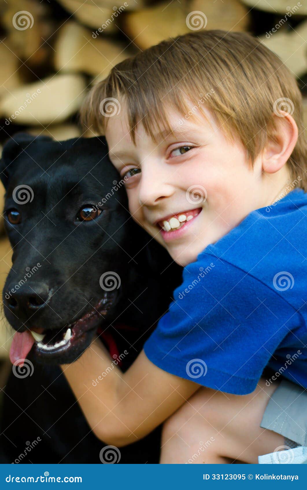 Boy hugging black dog stock image. Image of affectionate - 33123095