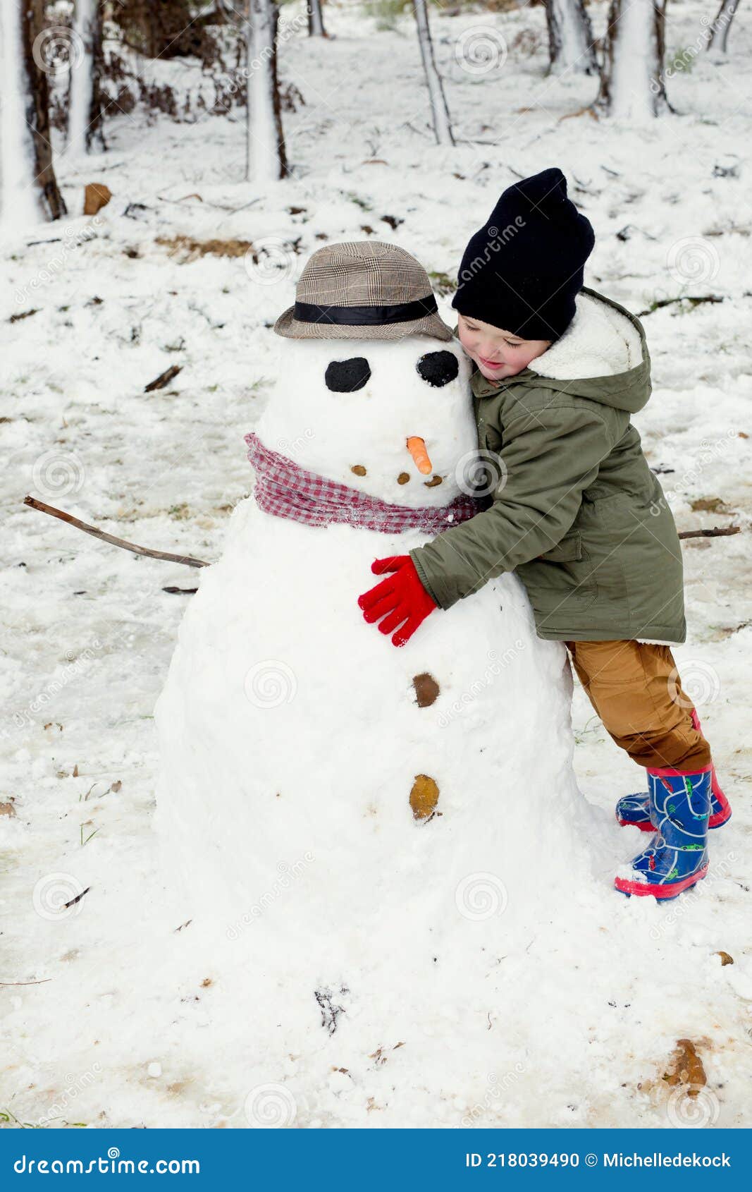 A Boy Hugging a Snowman in a Forest Stock Photo - Image of cold, built ...