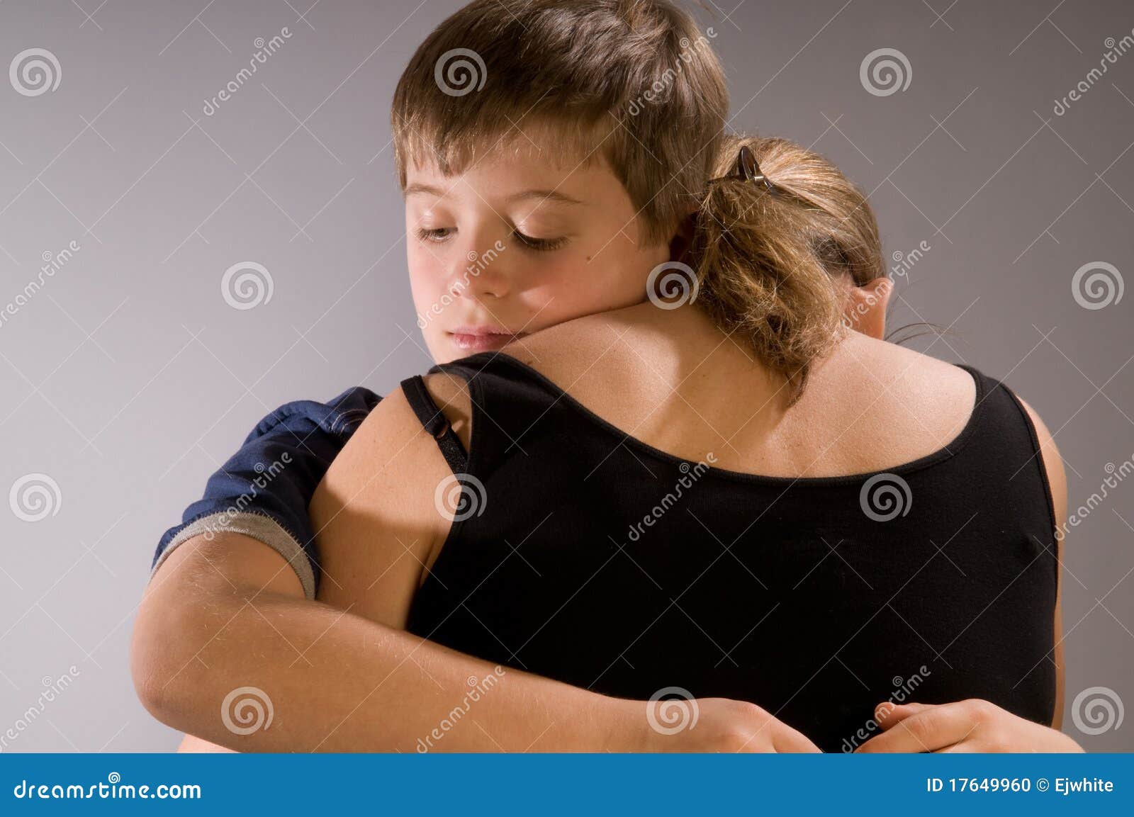 Boy hugs his mom stock photo. Image of emotional, studio - 17649960
