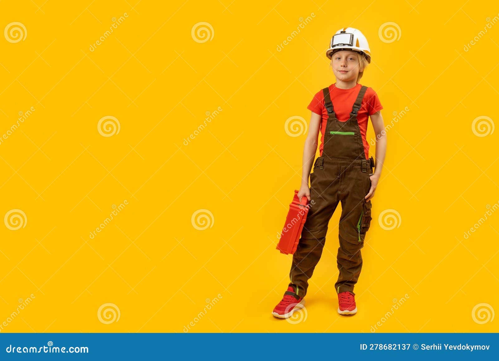 Boy Imitates Worker or Construction Worker. Child in Work Overalls and ...