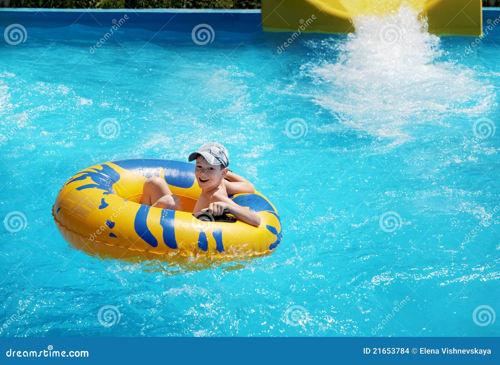 Boy on an inflatable disc stock photo. Image of water - 21653784