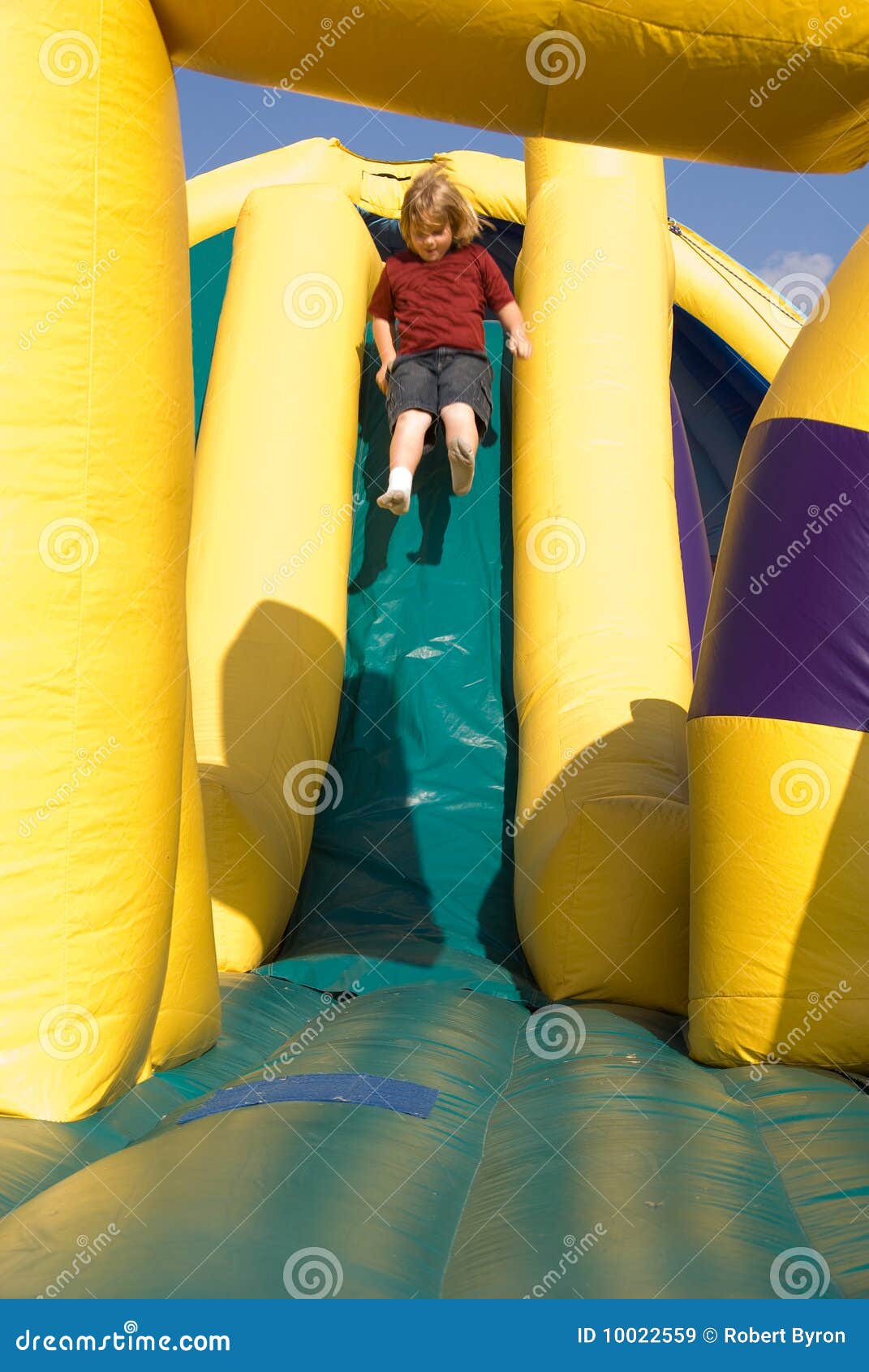 Boy on Inflatable Slide stock image. Image of people - 10022559