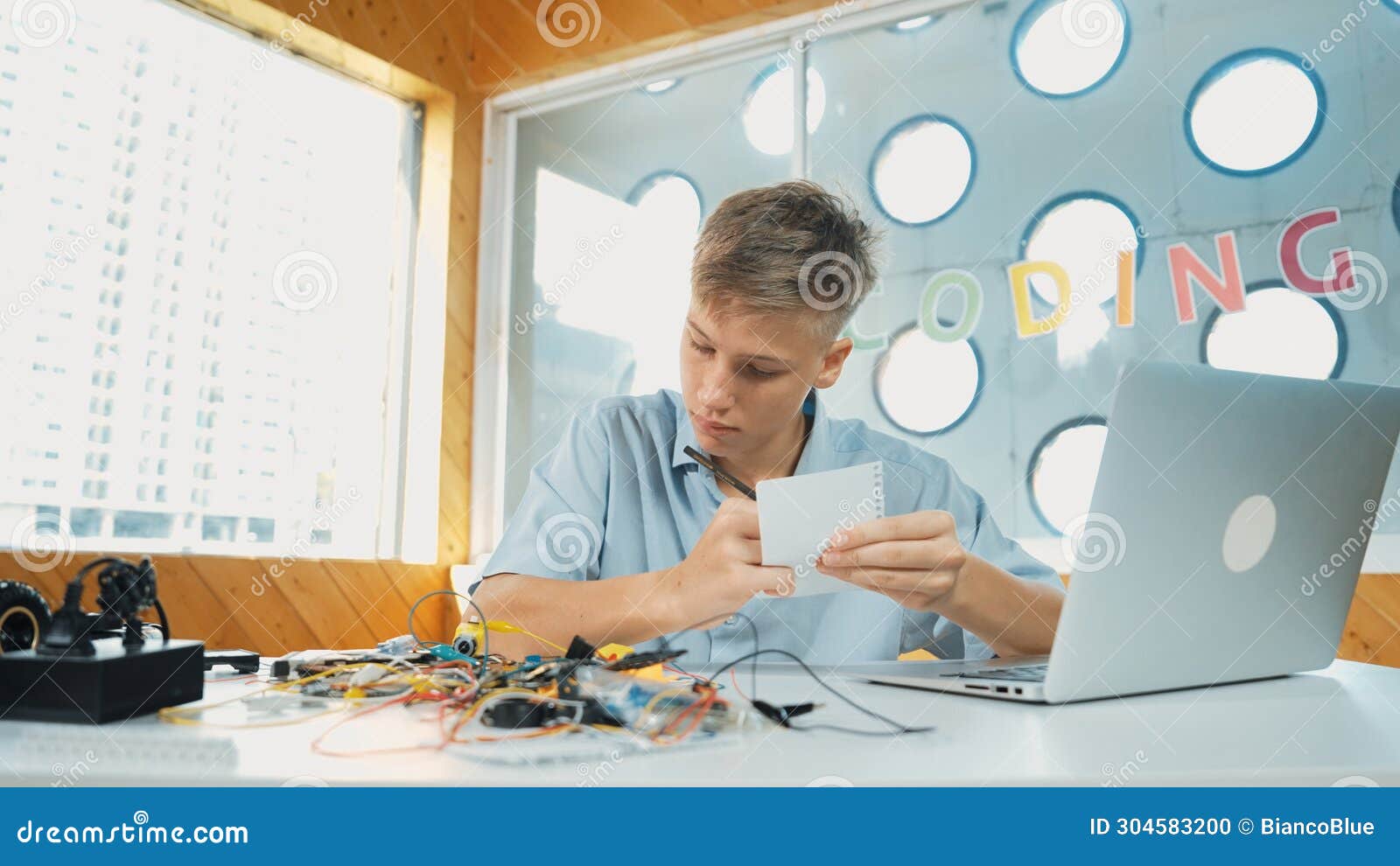 Boy Inspect or Learning To Use Electronic Tool while Taking a Note ...