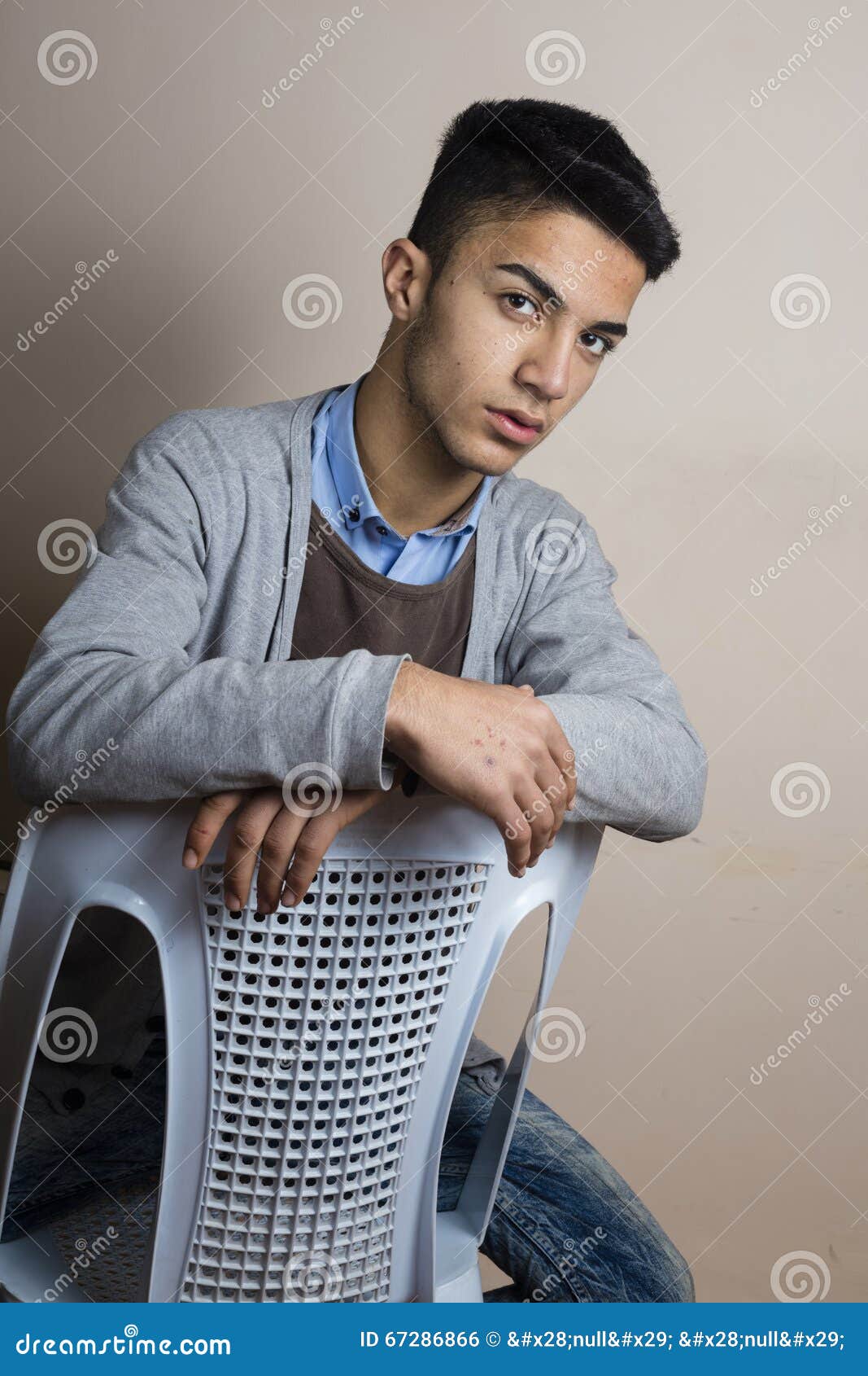 Boy Itting on Chair Inside Studio Stock Photo - Image of confident ...