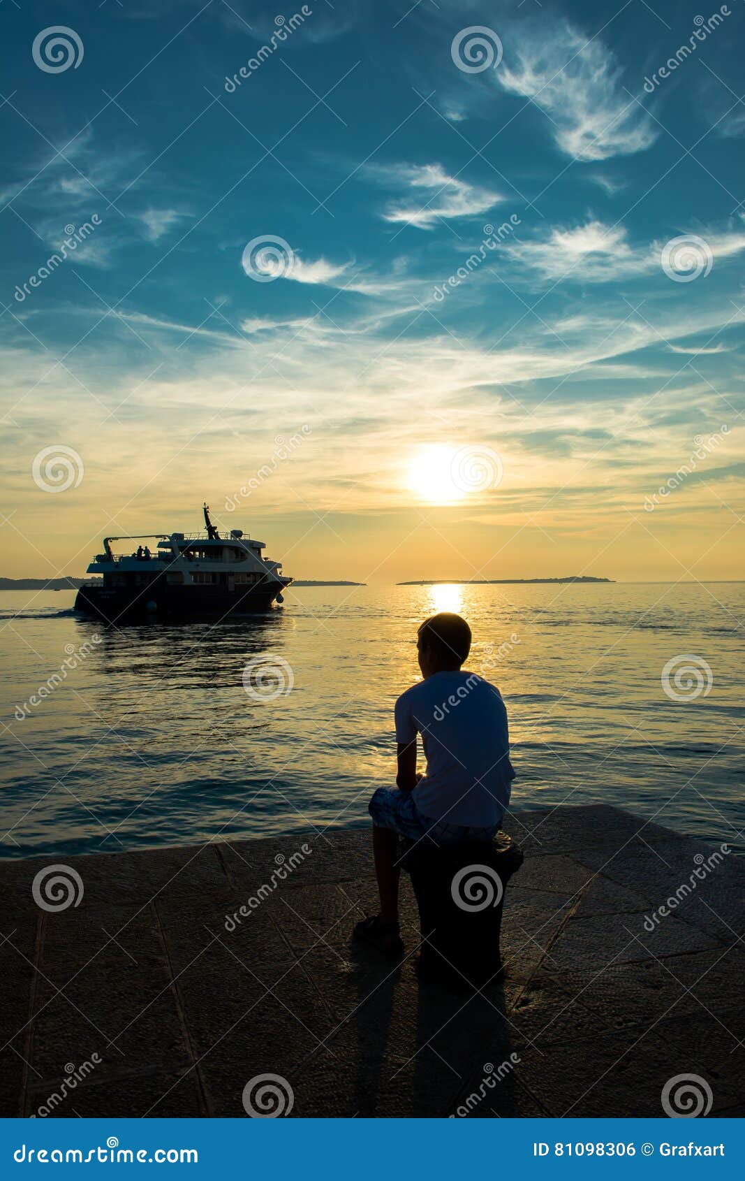 Boy On Jetty Watching Leaving Ship At Sunset Editorial Image ...