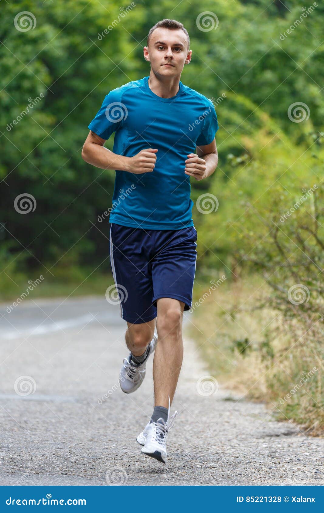 Boy jogging through forest stock photo. Image of energy - 85221328