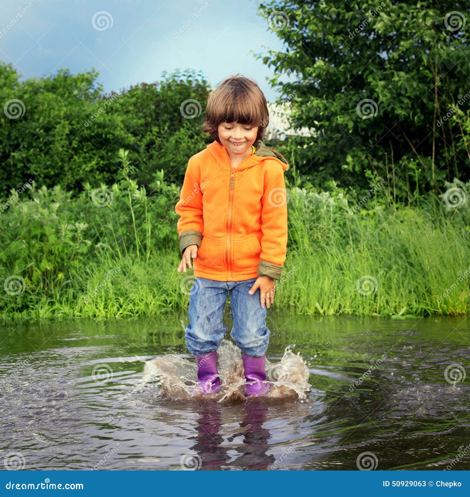 Boy jump in puddle stock image. Image of lifestyles, carefree - 50929063