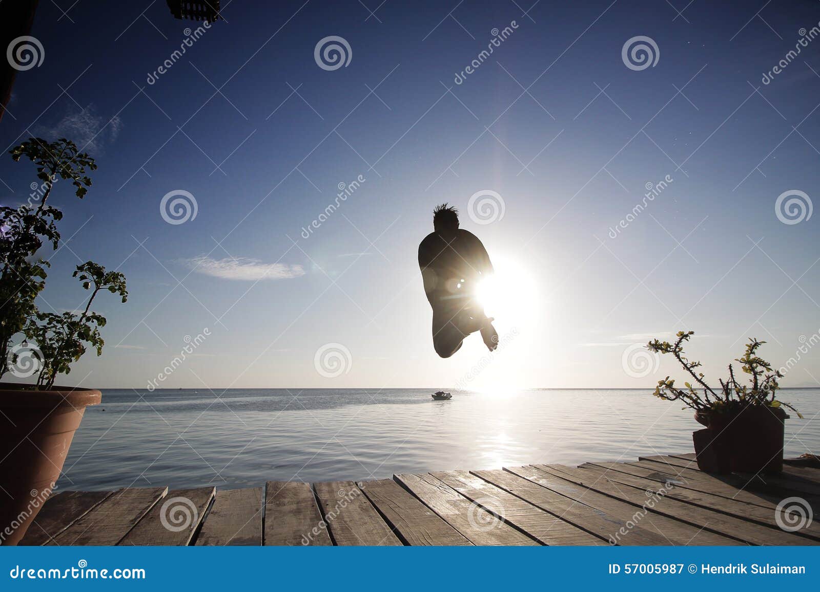 Boy Jump into the Sea from the Platform in the Evening Stock Image ...