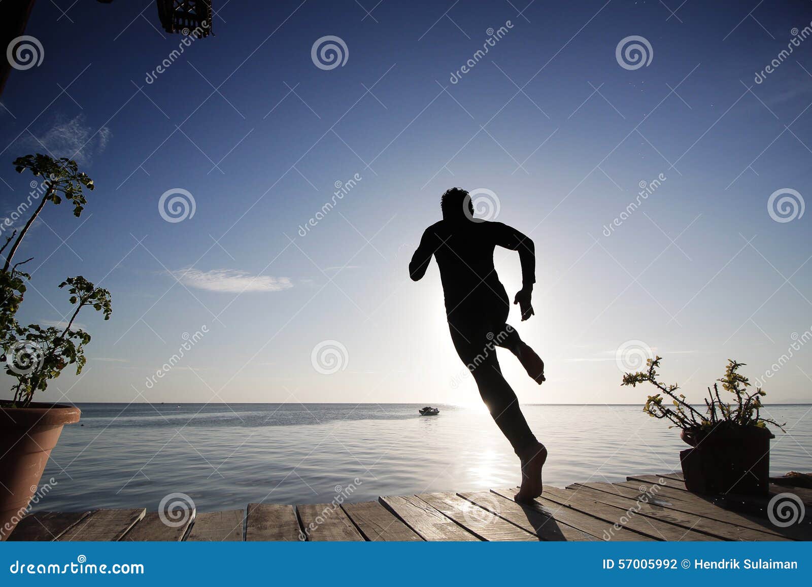 Boy Jump into the Sea from the Platform in the Evening Stock Photo ...