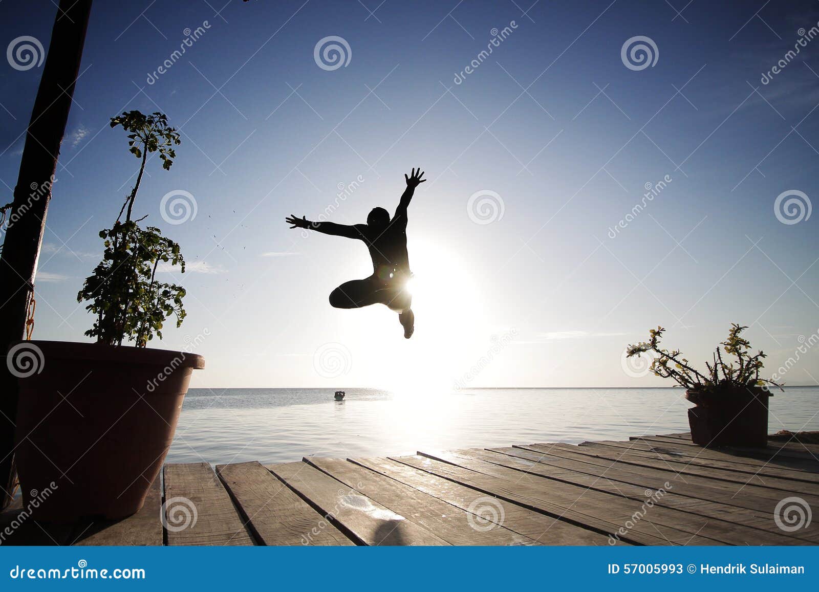 Boy Jump into the Sea from the Platform in the Evening Stock Image ...