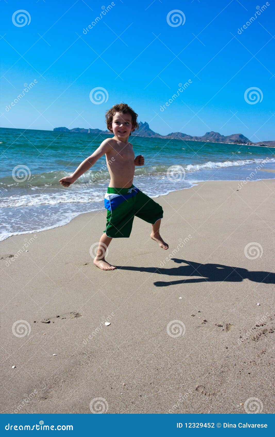 Boy Jumping Around on the Beach Stock Photo - Image of shadow, clear ...