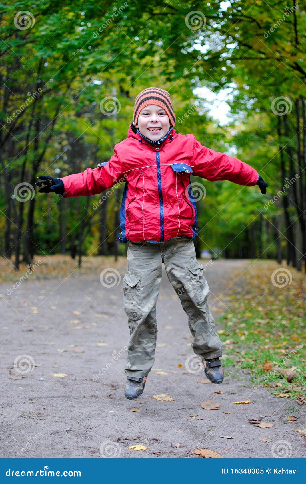 Boy jumping in autumn park stock image. Image of tree - 16348305