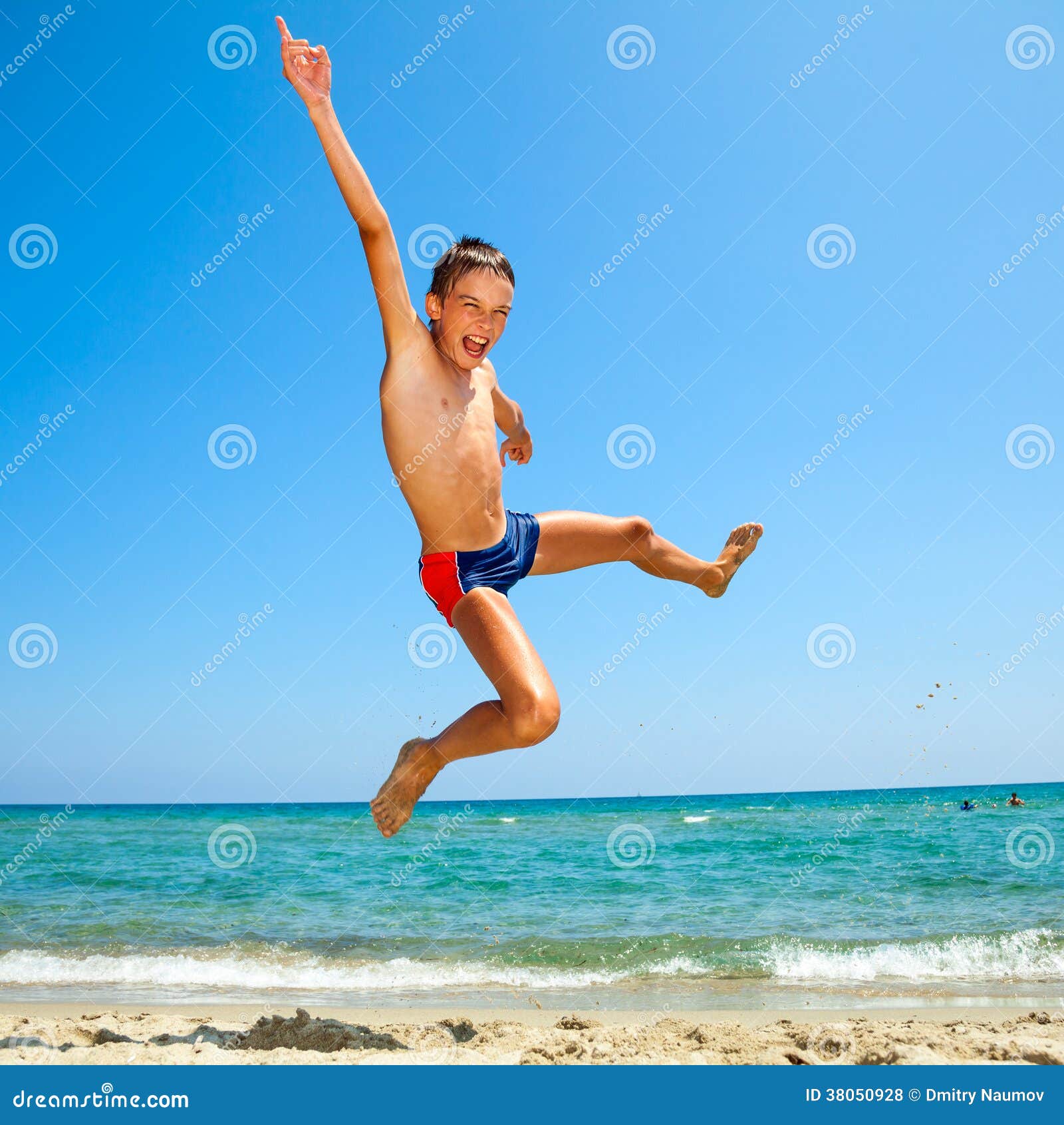 Boy jumping on the beach stock photo. Image of brown - 38050928
