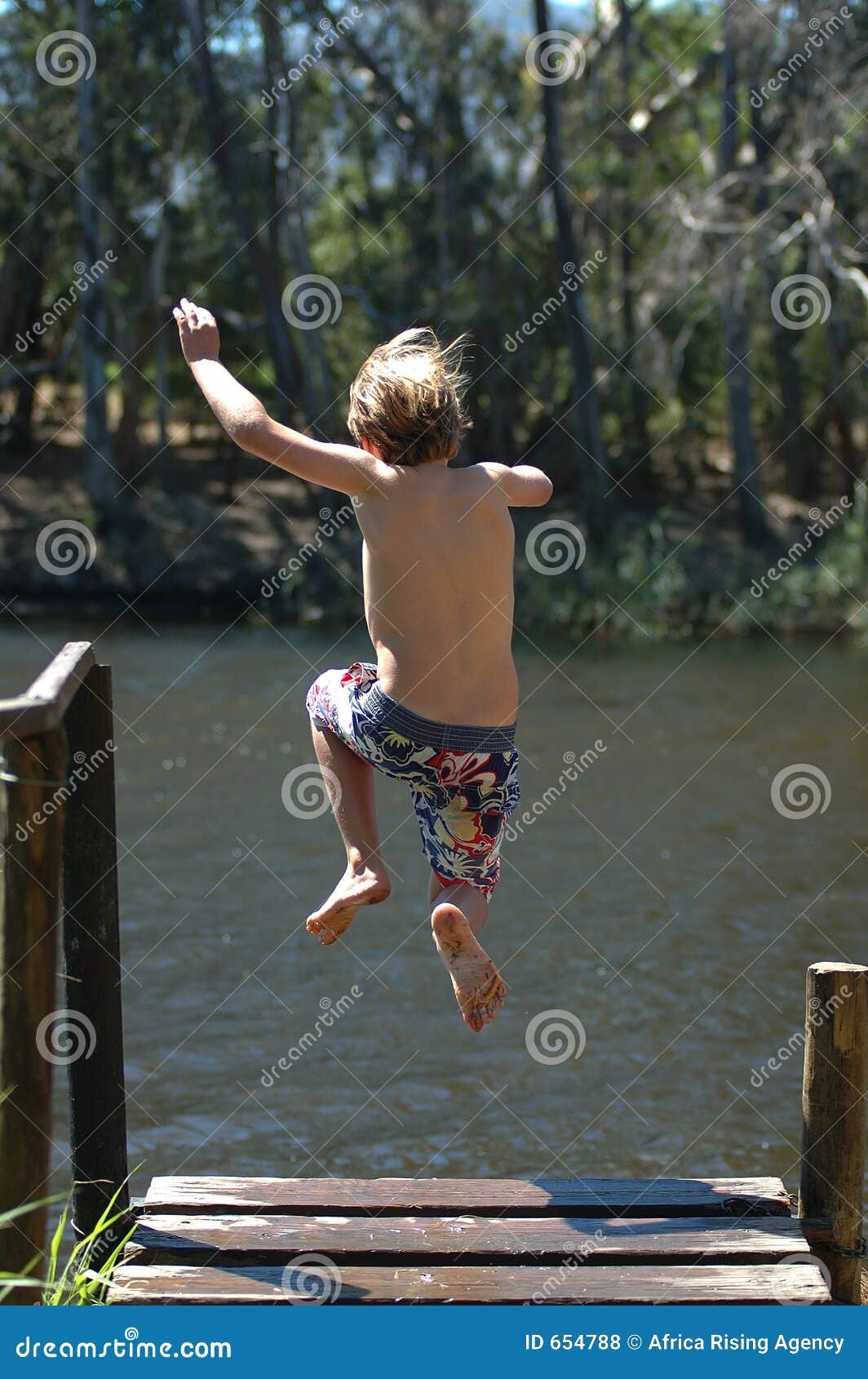 Boy jumping into lake stock photo. Image of swim, happiness - 654788