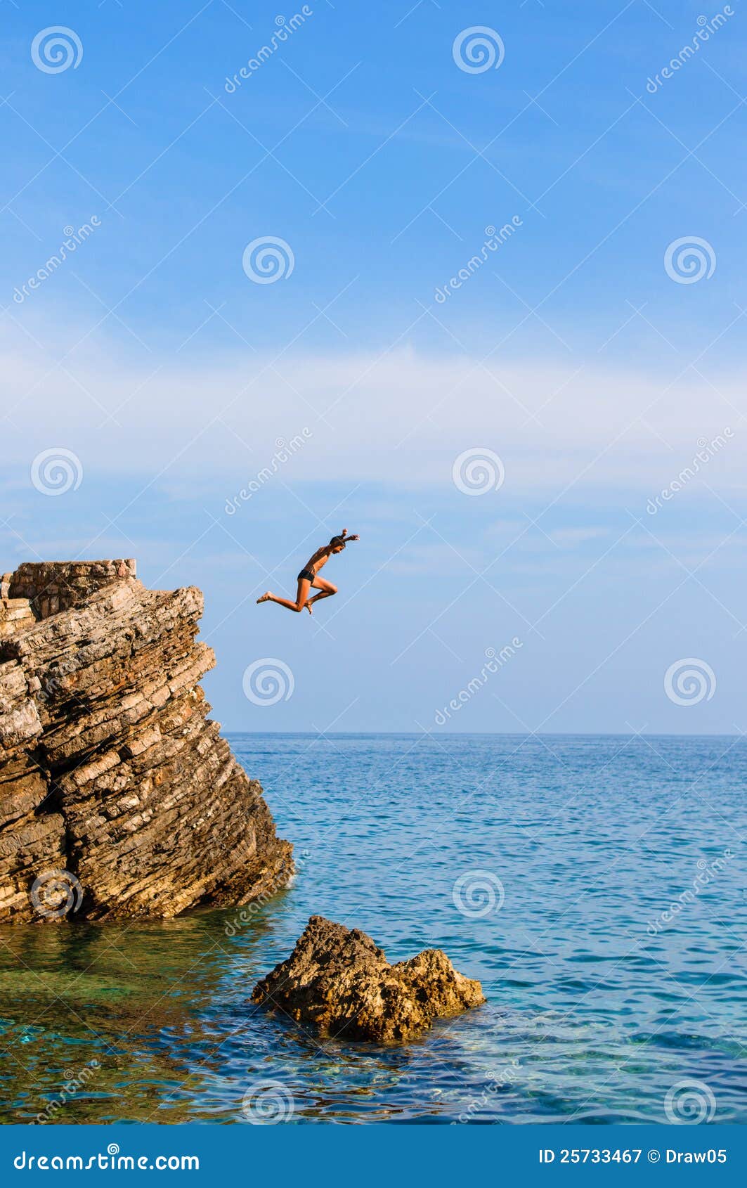 Boy Jumping Off Cliff into Blue Water Stock Image - Image of energy ...