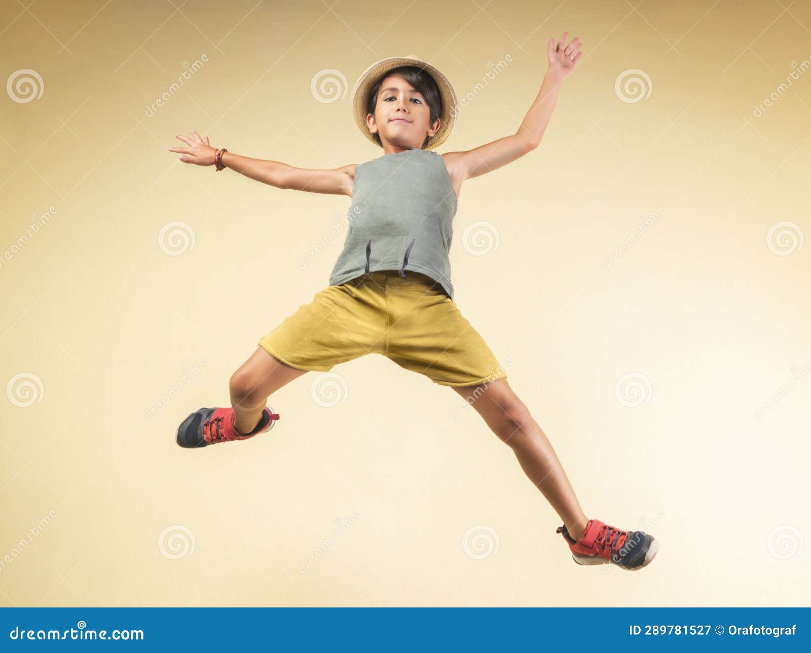 Boy Jumping with Open Arms and Legs and Wearing a Straw Hat Stock Image ...
