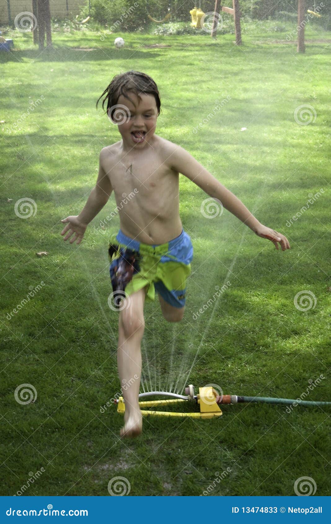 Boy Jumping Over Lawn Sprinkler Stock Image - Image of happy, jump ...