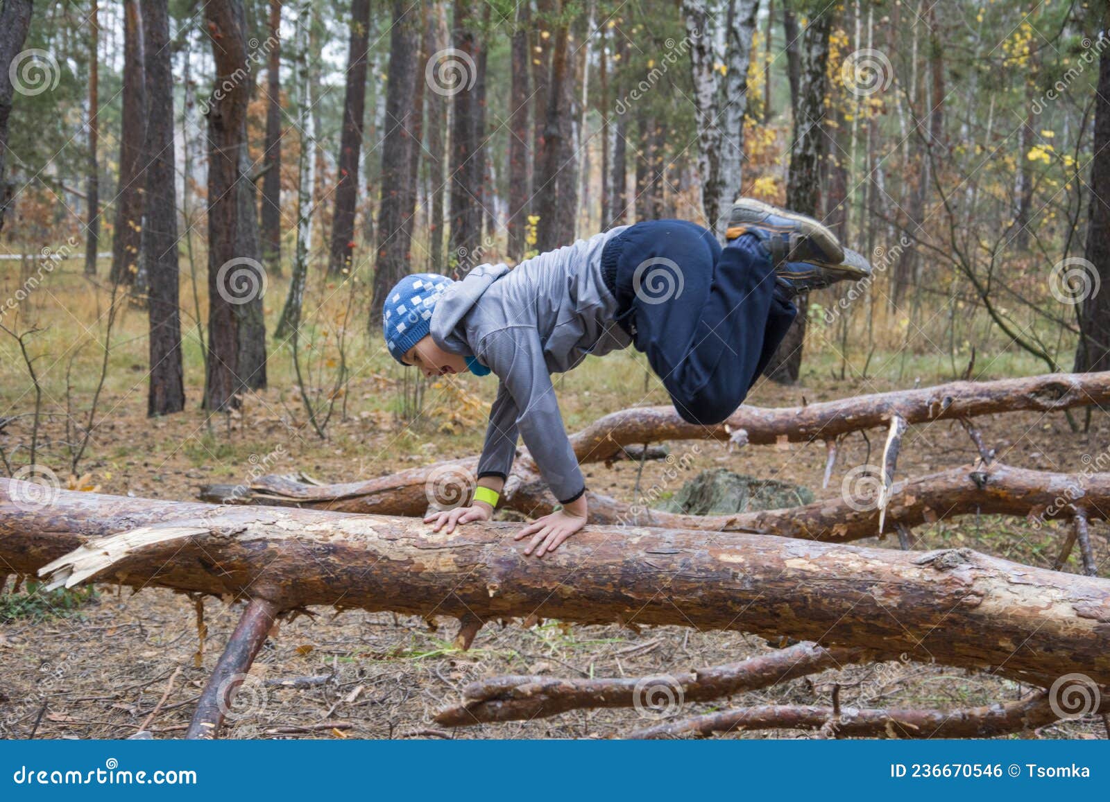 Boy Jumping Over a Log in the Autumn Forest Stock Photo - Image of ...