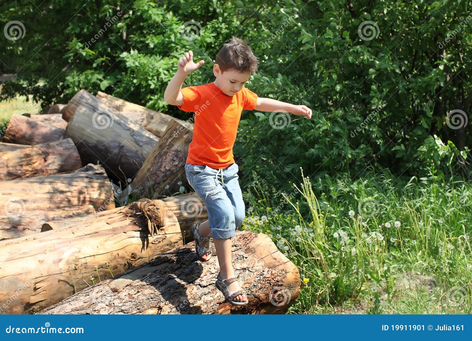 Boy Jumping Over Logs Stock Image - Image: 19911901