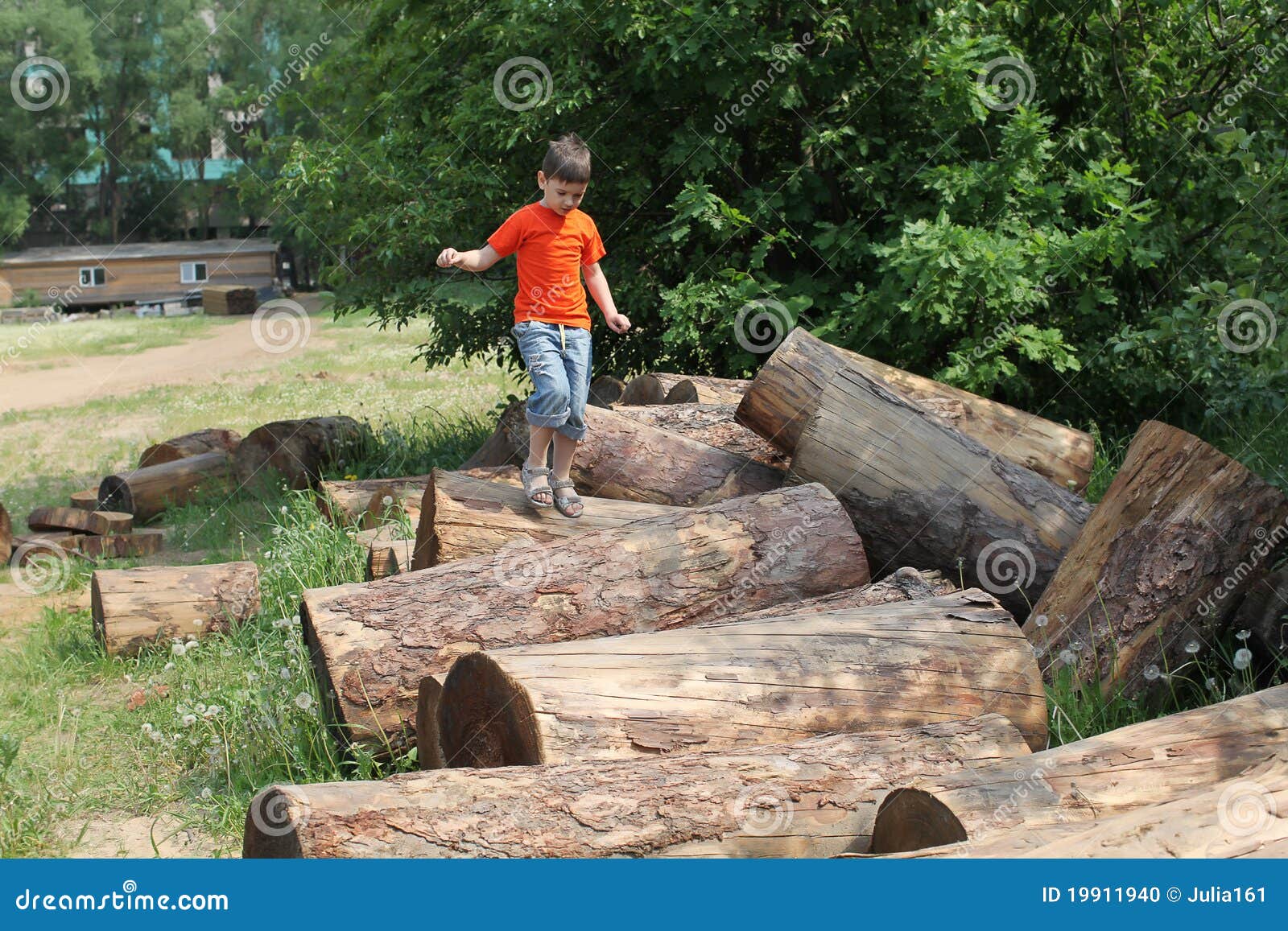 Boy jumping over logs stock photo. Image of child, jump - 19911940