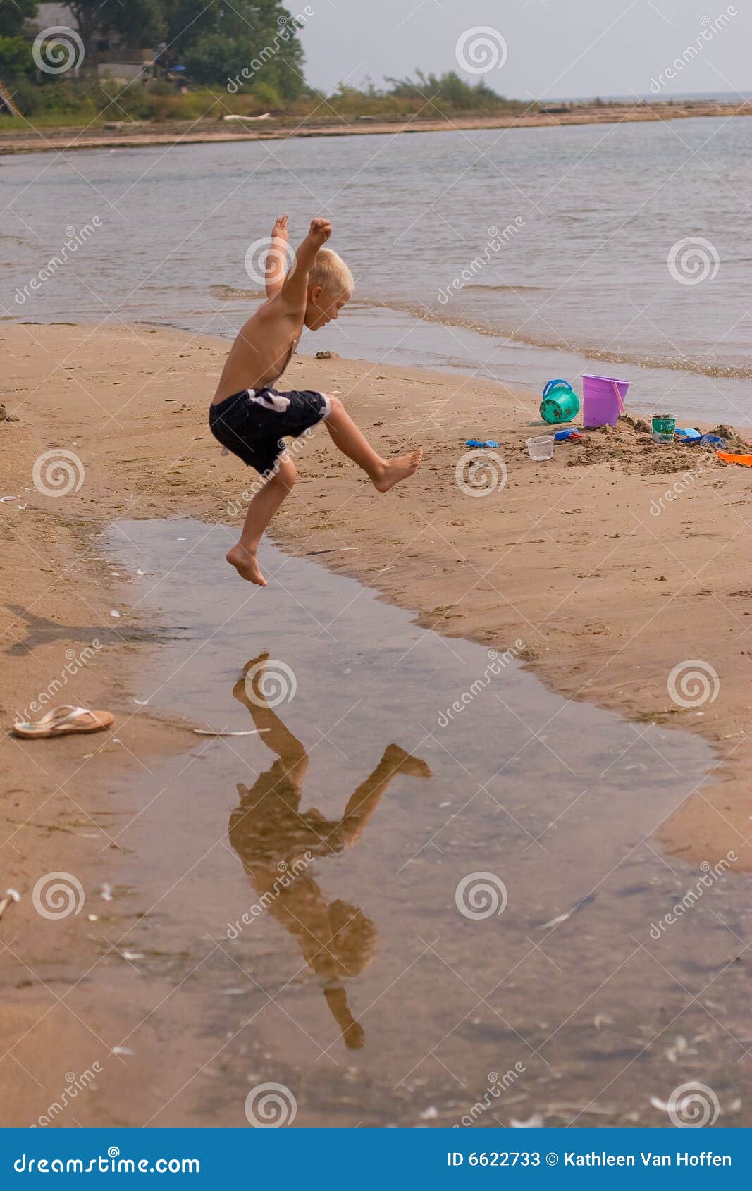 Boy jumping over puddle stock image. Image of happy, jumping - 6622733