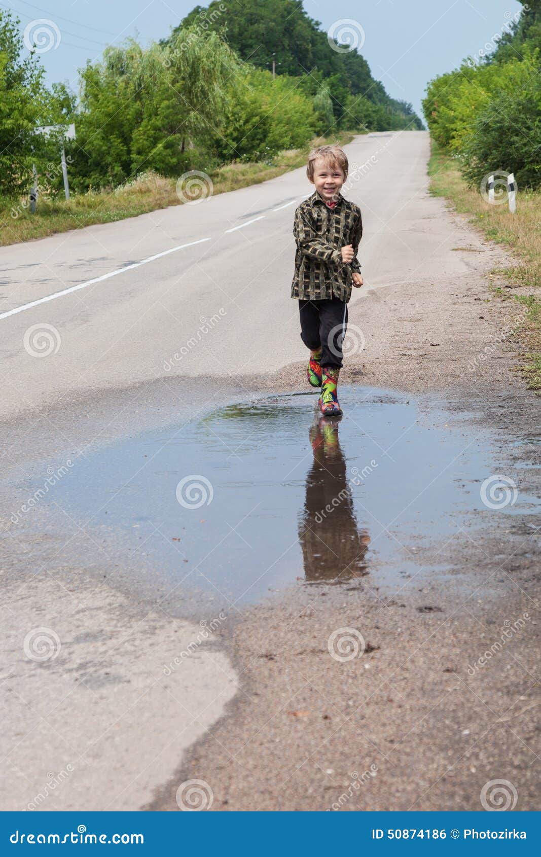 Boy jumping in puddles stock photo. Image of puddle, people - 50874186
