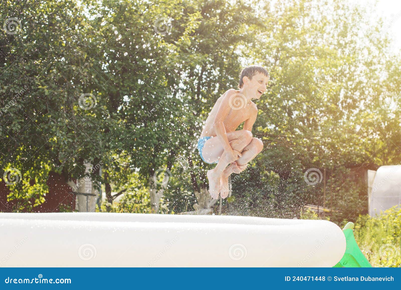 Boy Jumping into the Swimming Pool in the Garden at Summer Stock Photo ...