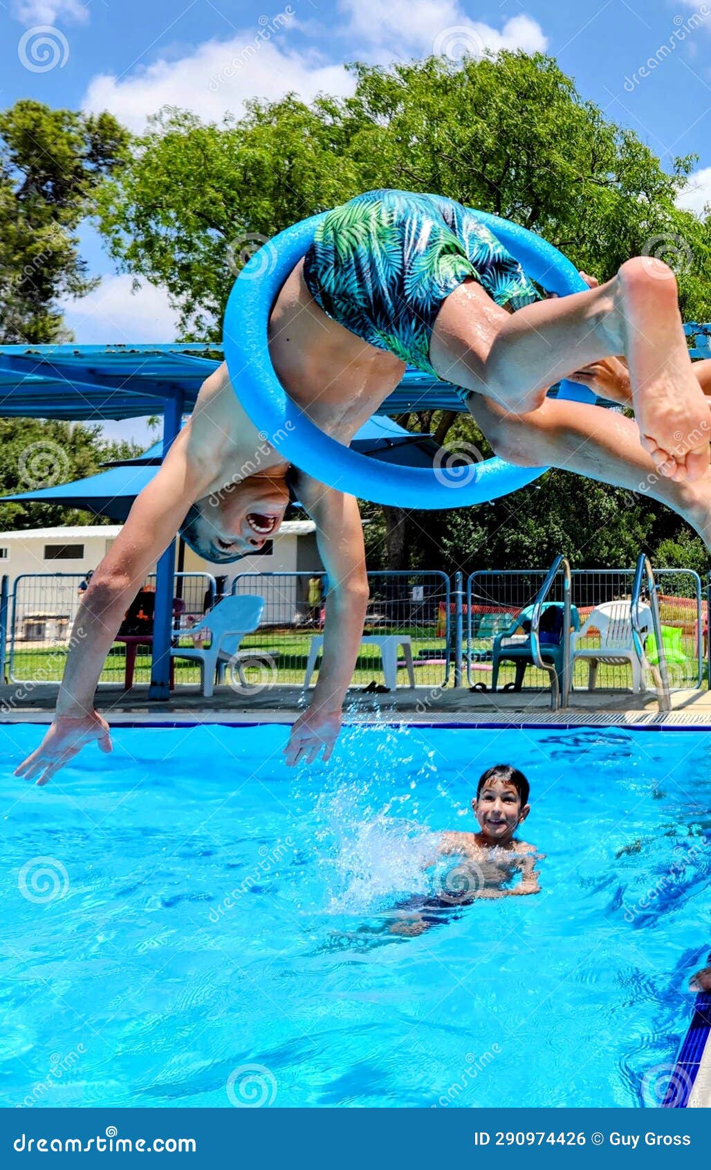 Boy Jumping into the Swimming Pool through a Ring Stock Photo - Image ...