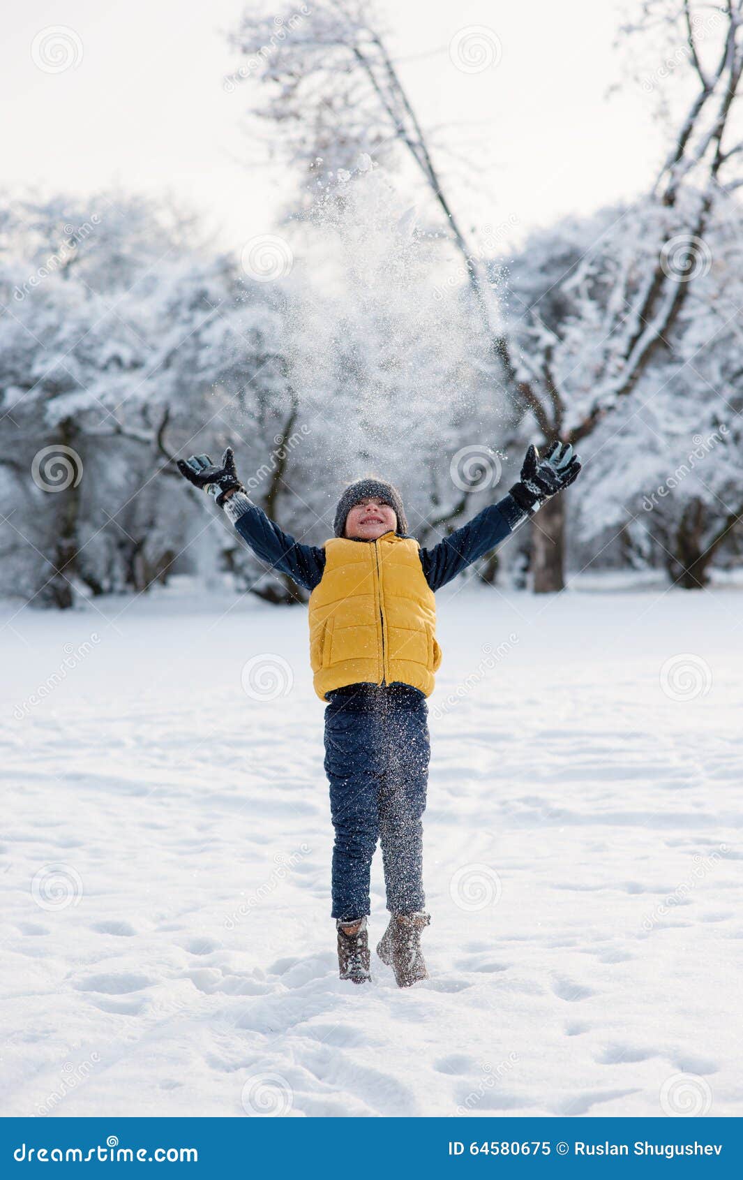 Boy Jumping Throwing Snow Up Near the Forest Stock Image - Image of ...