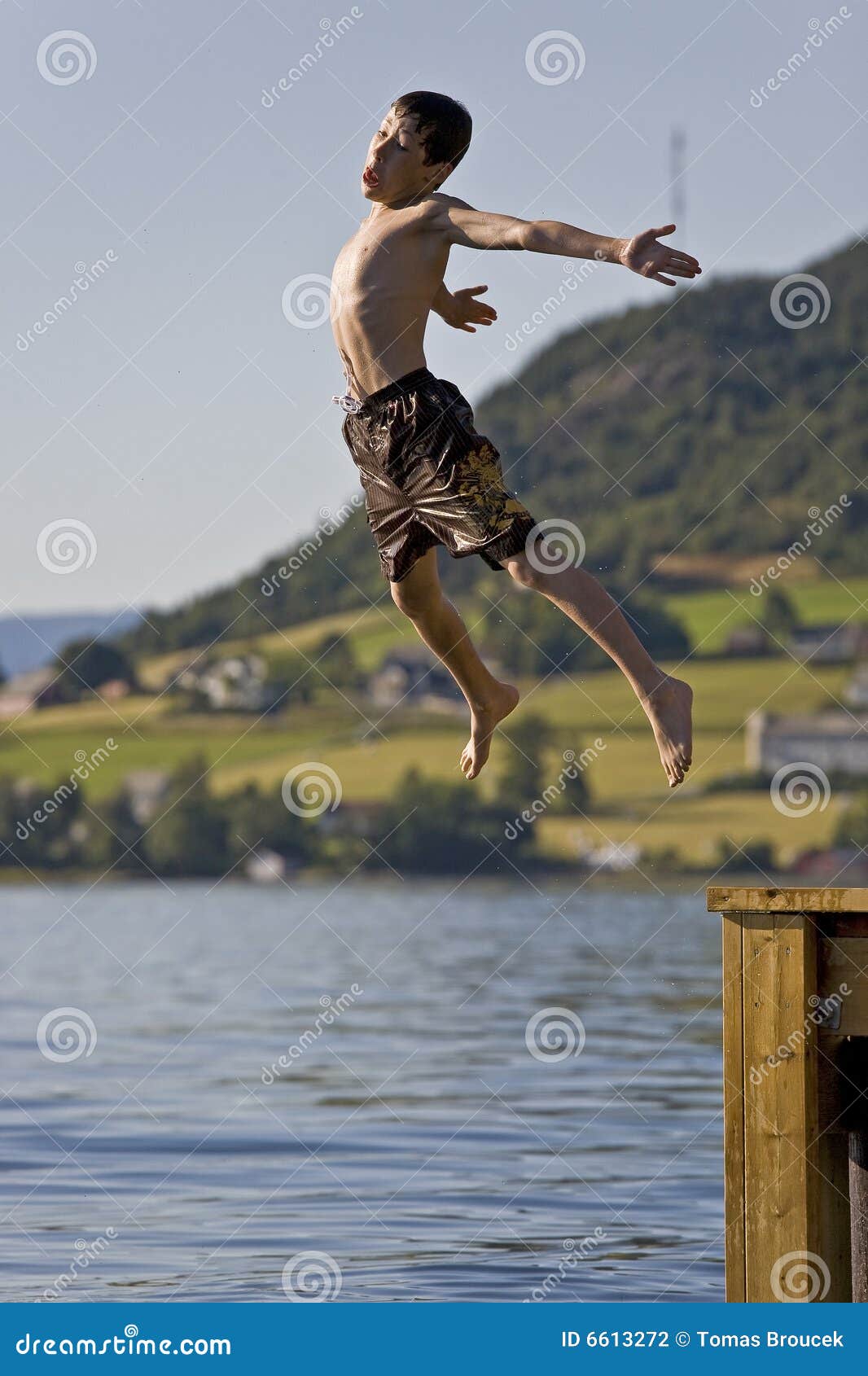 Boy Jumping To Lake, Norway Stock Photo - Image of active, posture: 6613272