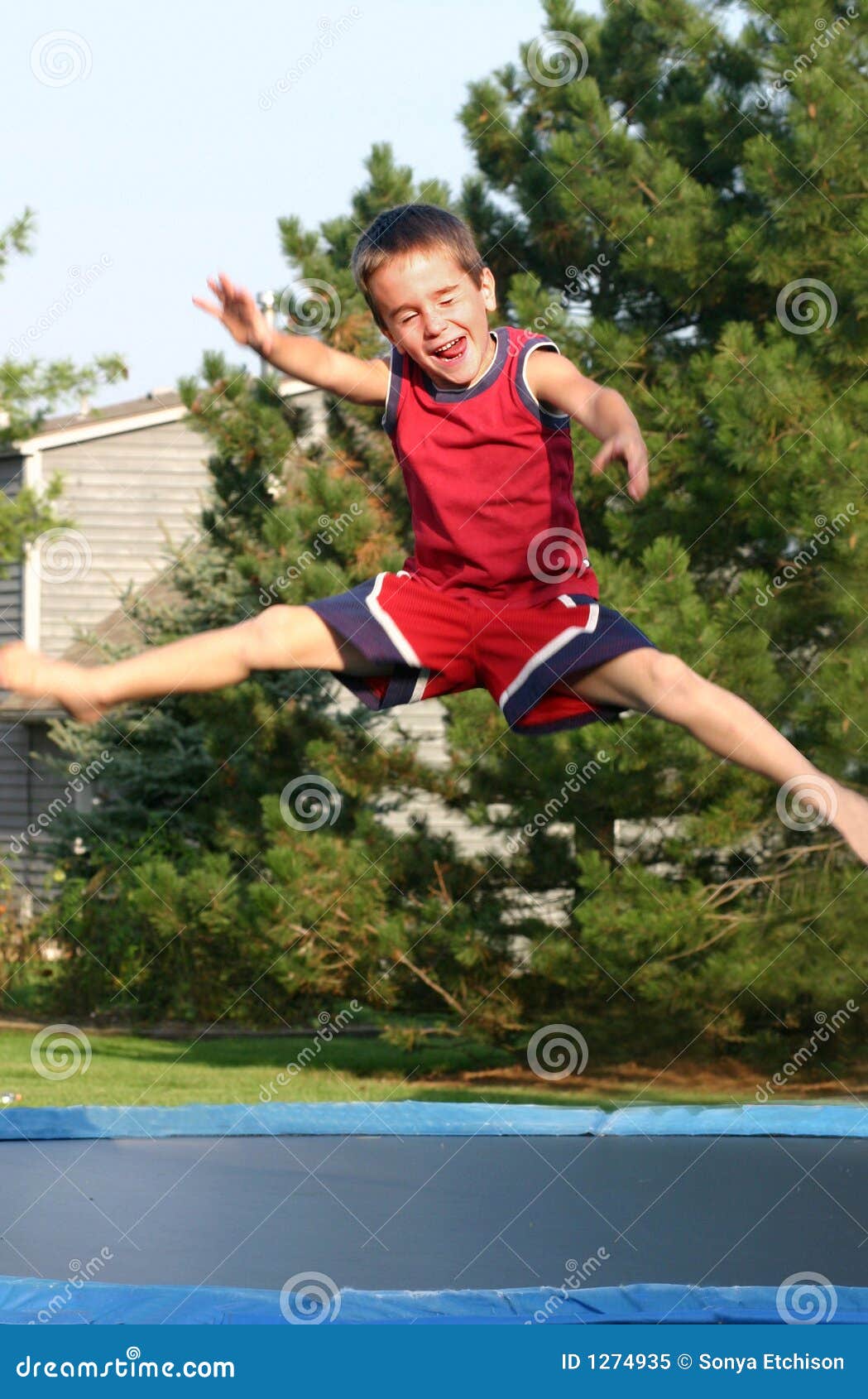 Boy Jumping on Trampoline stock image. Image of little - 1274935
