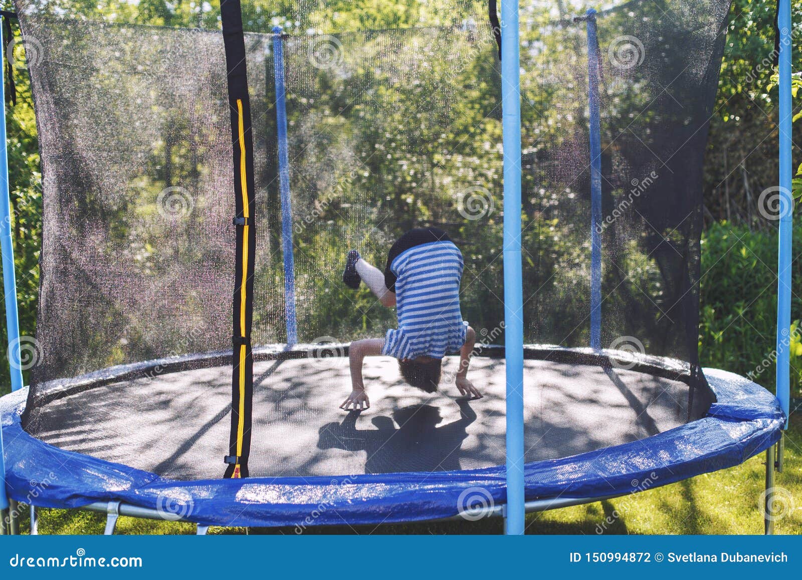 Boy Jumping on Trampoline. a Child is Tumbling Stock Photo - Image of ...