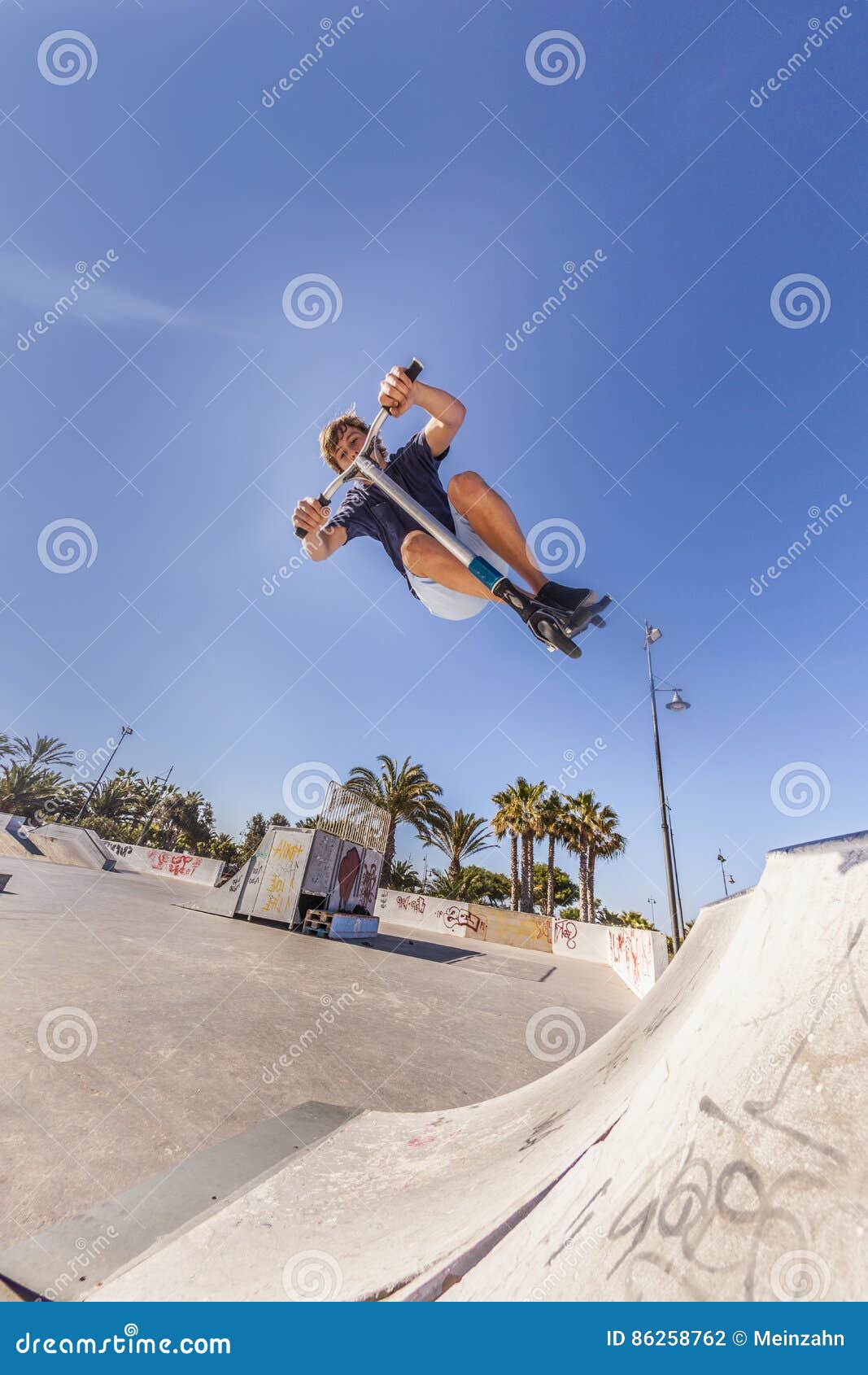 Boy Jumps with His Scooter Over a Ramp Stock Photo - Image of pipe ...