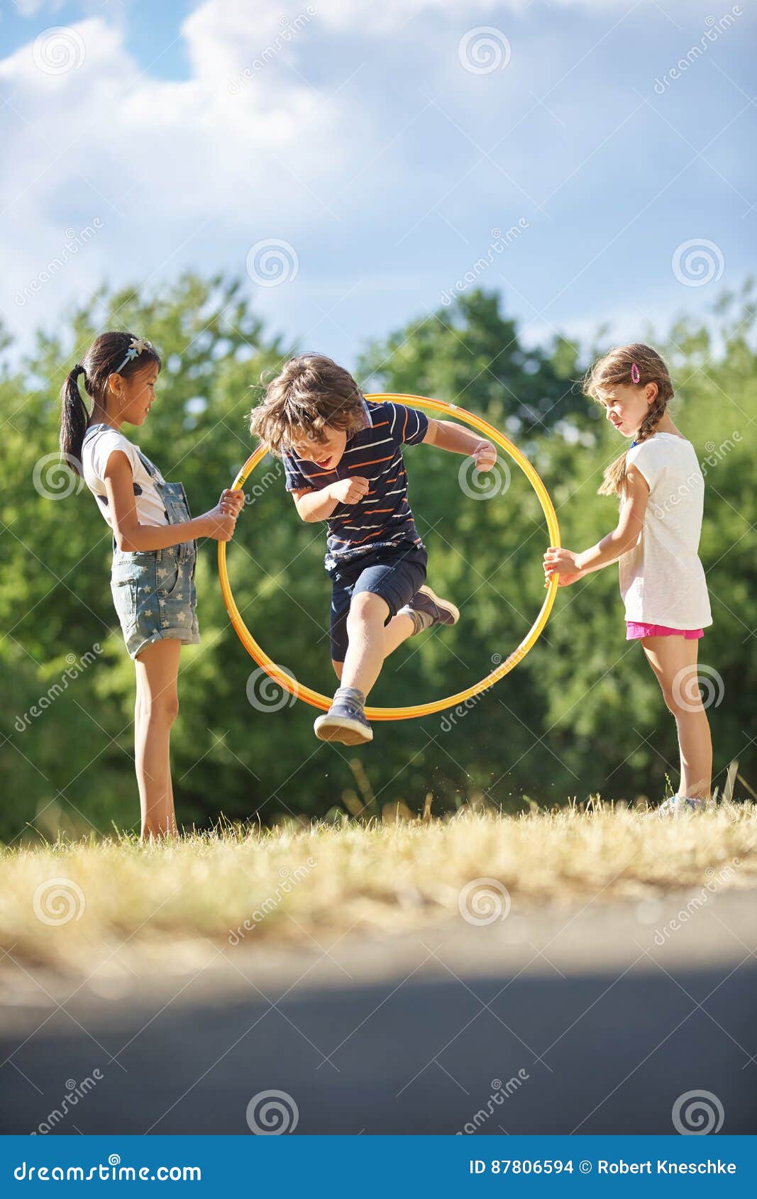 Boy Jumps through Hula Hoop Stock Photo - Image of kindergarten, nature ...