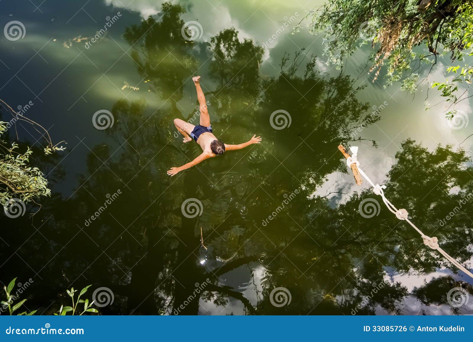 A Boy Jumps in a Lake with a Bungee Jumping Stock Photo - Image of boys ...