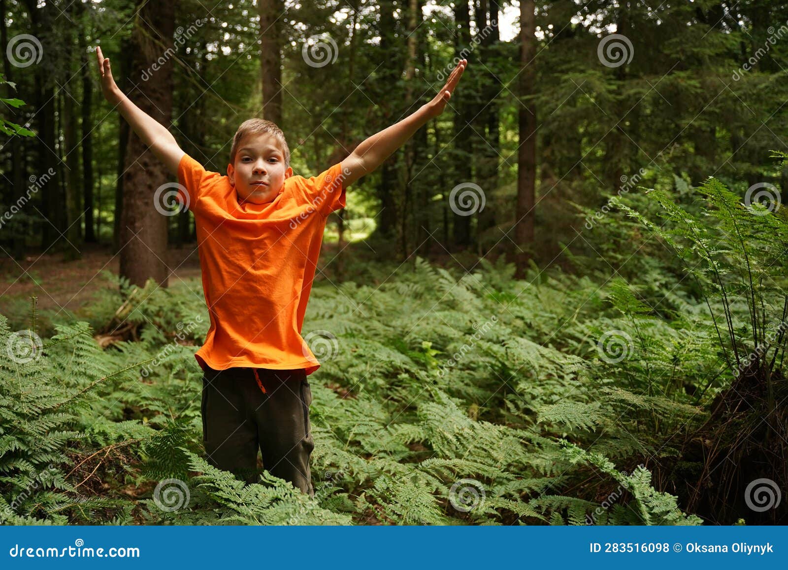 A Boy Jumps Out of the Bushes in the Forest. Stock Photo - Image of ...