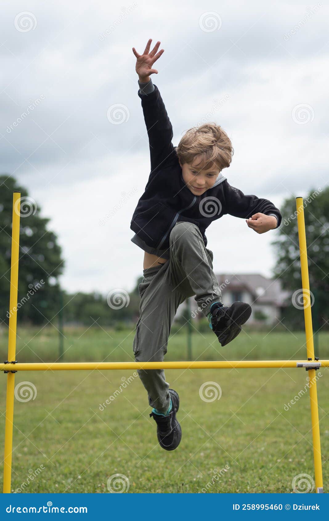 Boy Jumps Up Over the Obstacle Stock Photo - Image of exercise, blonde ...