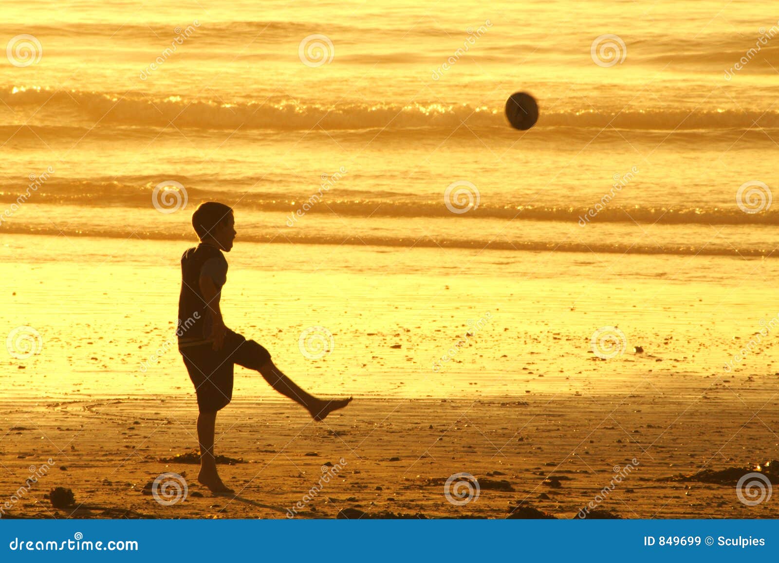 Boy kicking ball on beach stock image. Image of beach, ball - 849699
