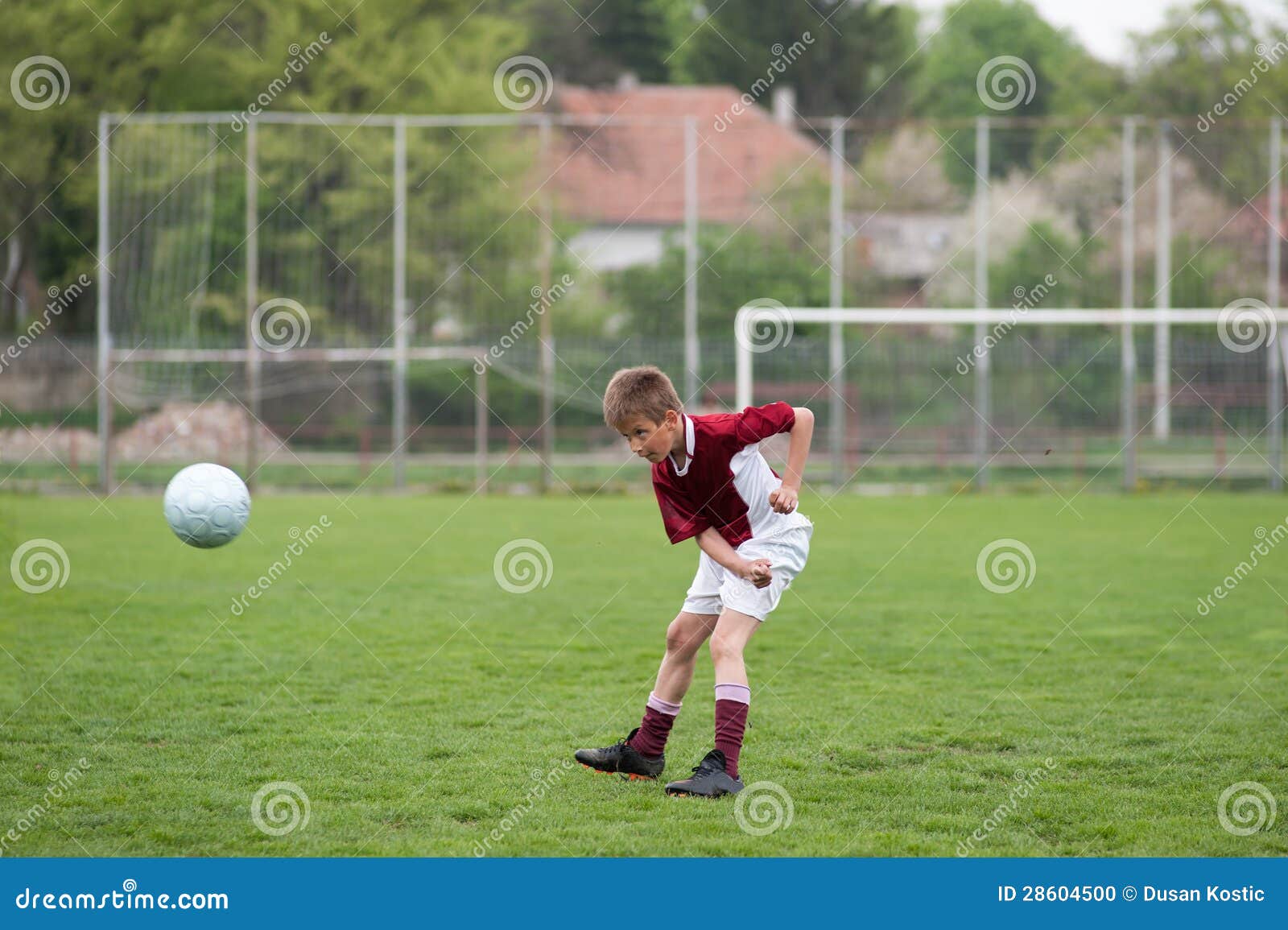 Boy kicking football stock photo. Image of equipment - 28604500